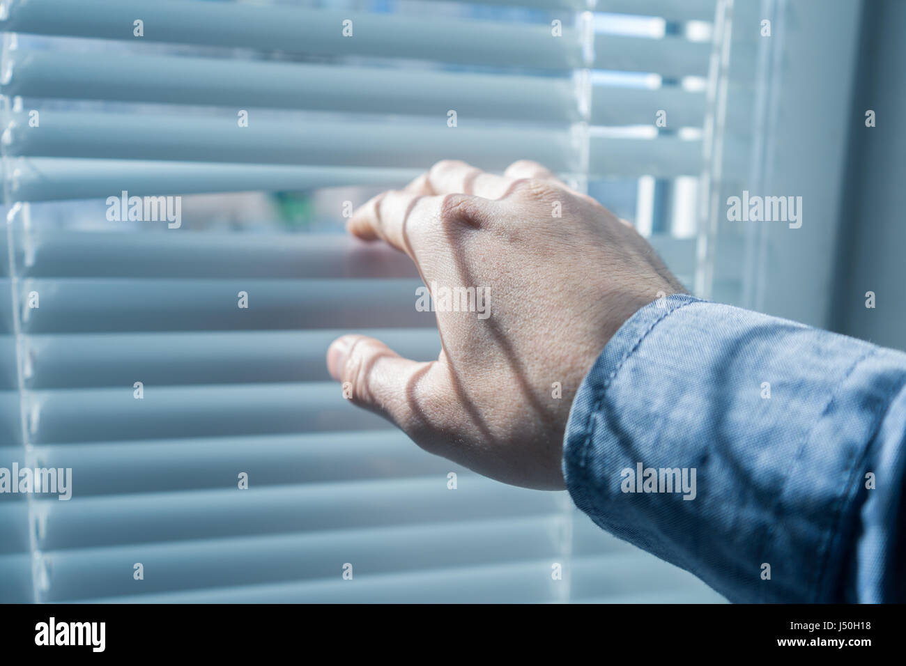 Hand opening blinds hi-res stock photography and images - Alamy