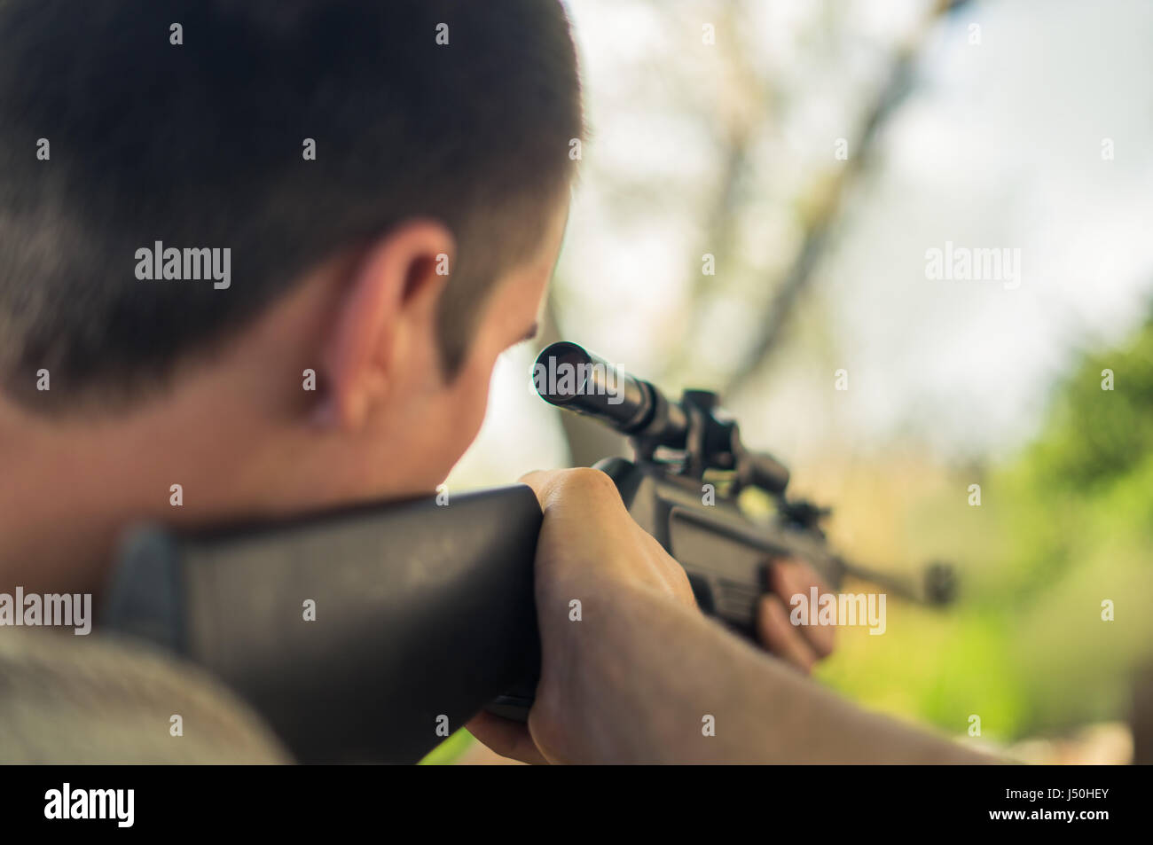 The man takes aim at the target with a sniper rifle. Selective Focus ...