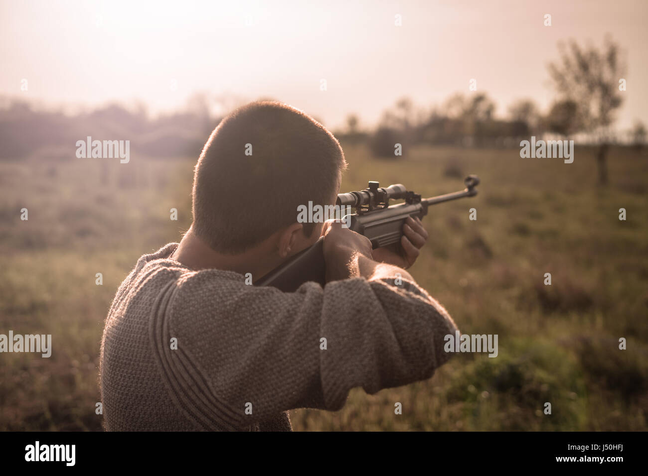The man takes aim at the target with a sniper rifle. Selective Focus ...