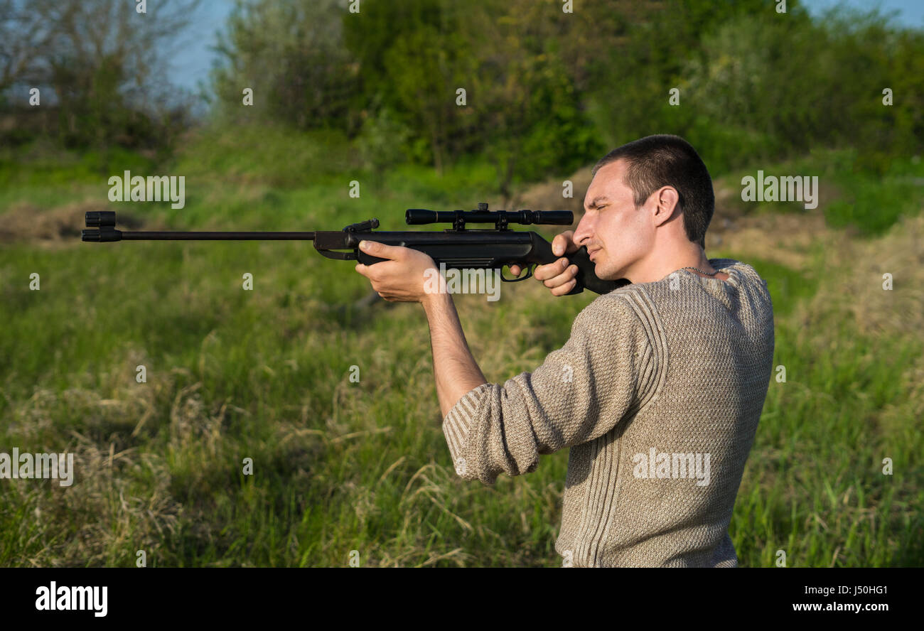 The man takes aim at the target with a sniper rifle. Selective Focus ...