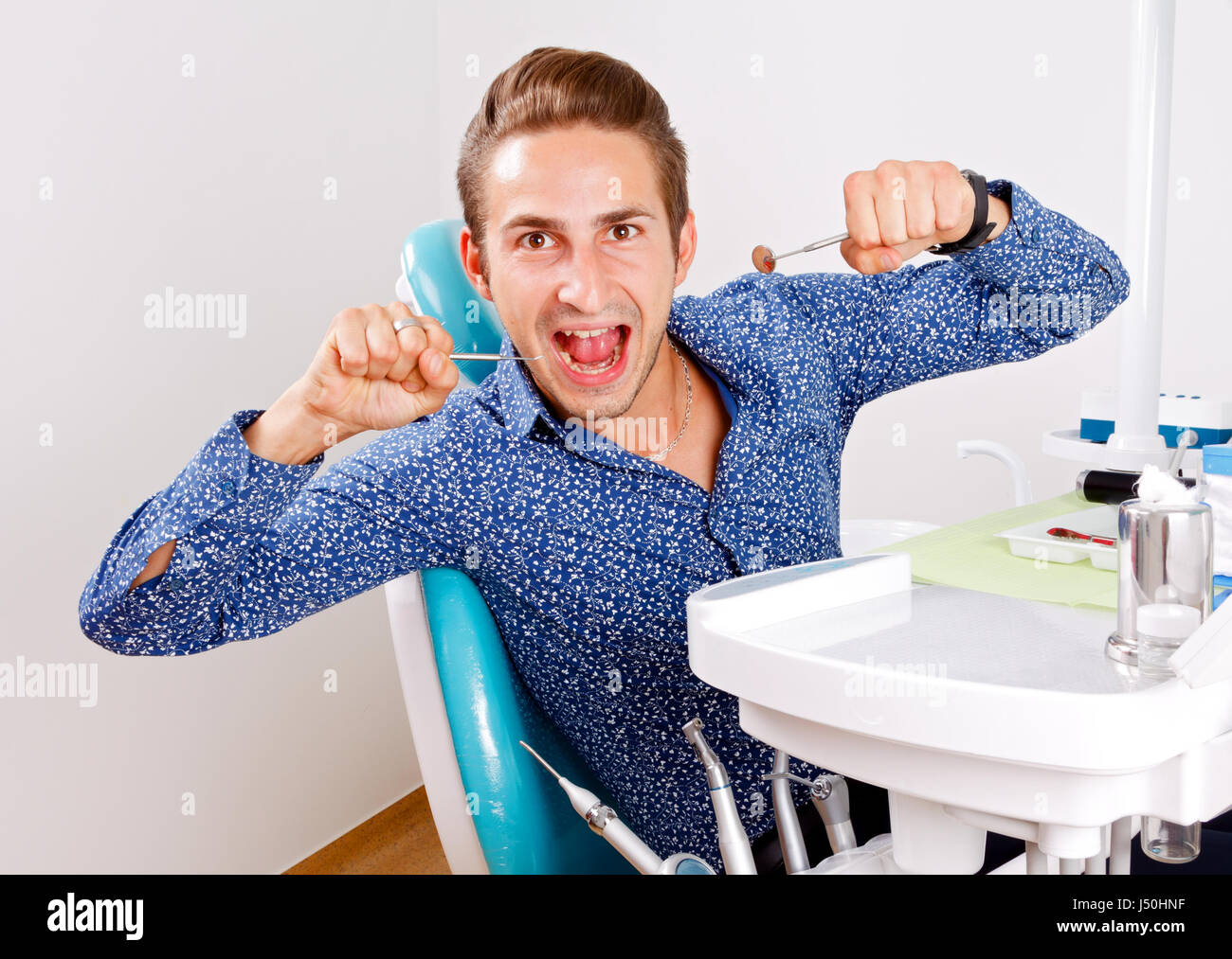 Crazy patient sitting in a dental chair Stock Photo - Alamy