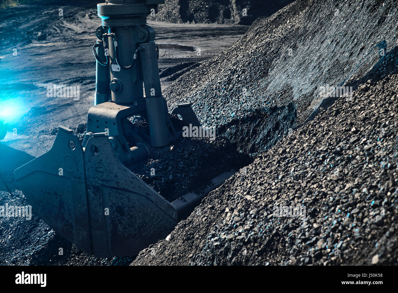 Coal loading excavator, heaps of coal Stock Photo - Alamy