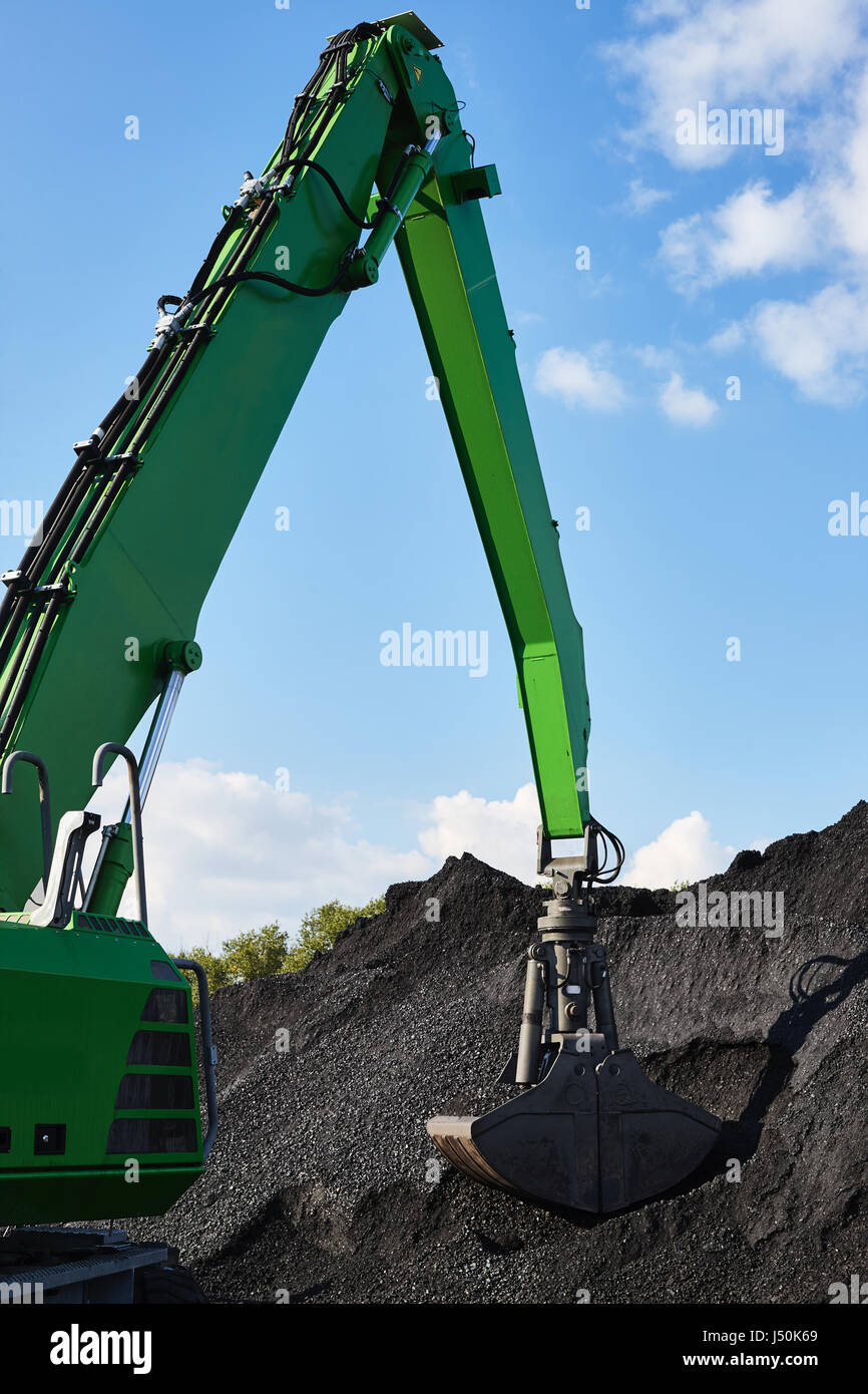 Coal loading excavator, heaps of coal Stock Photo - Alamy