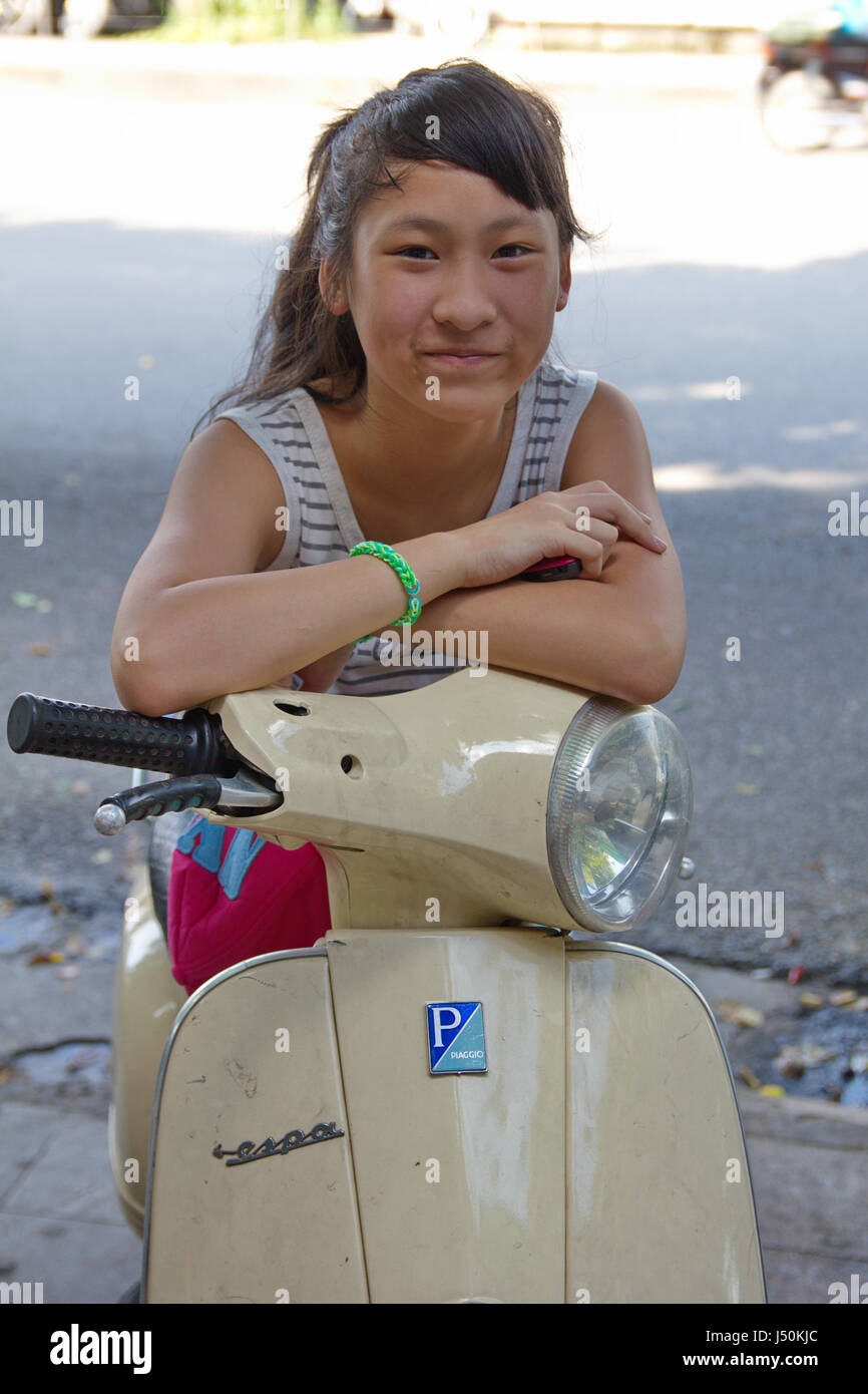 Girl rests on her Vespa scooter, Hanoi, Vietnam Stock Photo - Alamy