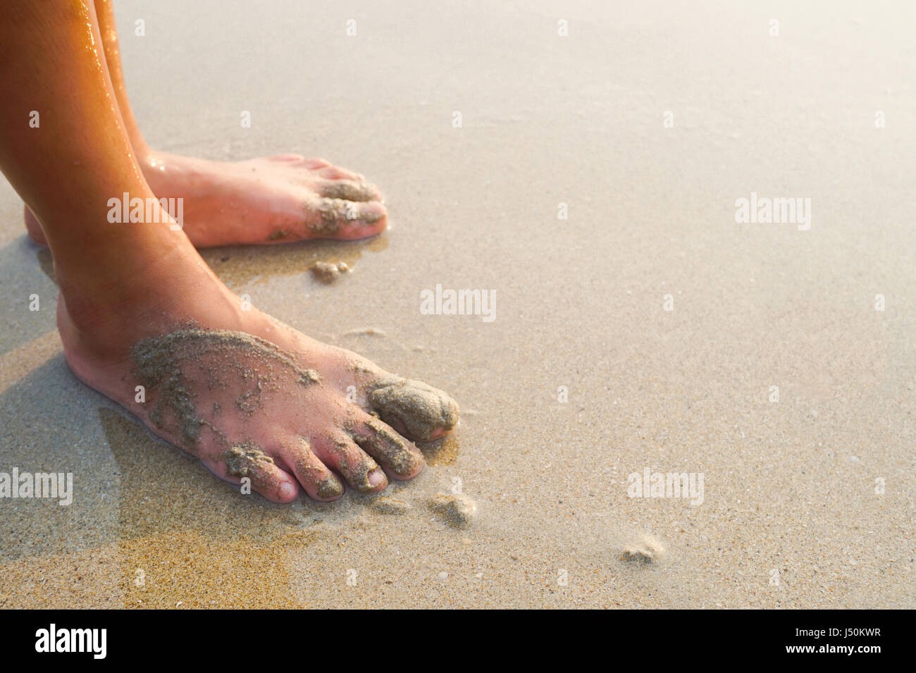 Child feet on sand hi-res stock photography and images - Alamy