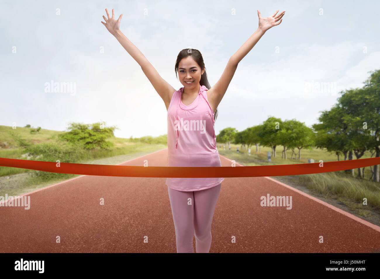 Excited asian woman runner crossing the finish line of a marathon Stock ...