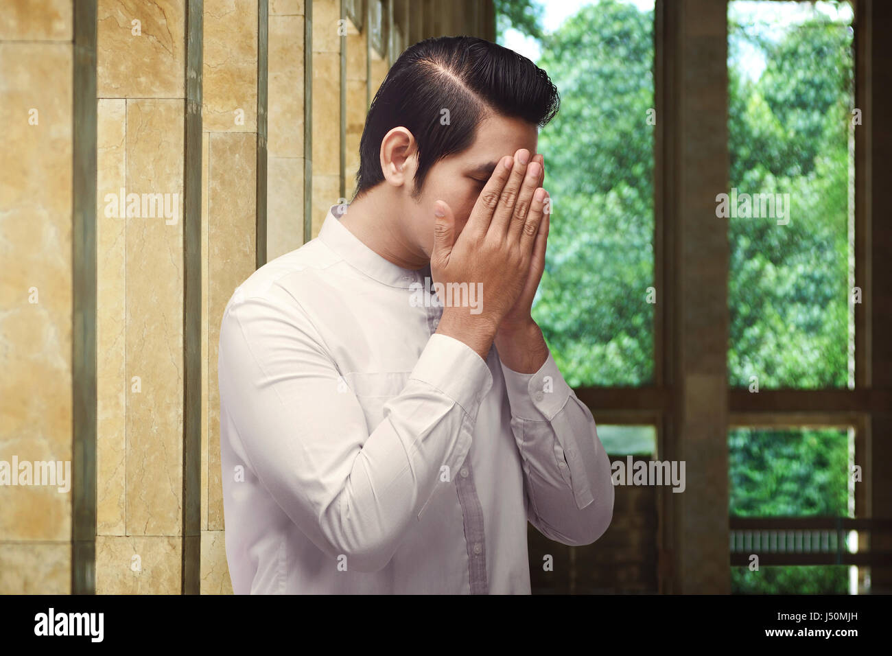 Handsome asian muslim man standing and praying in the mosque Stock ...