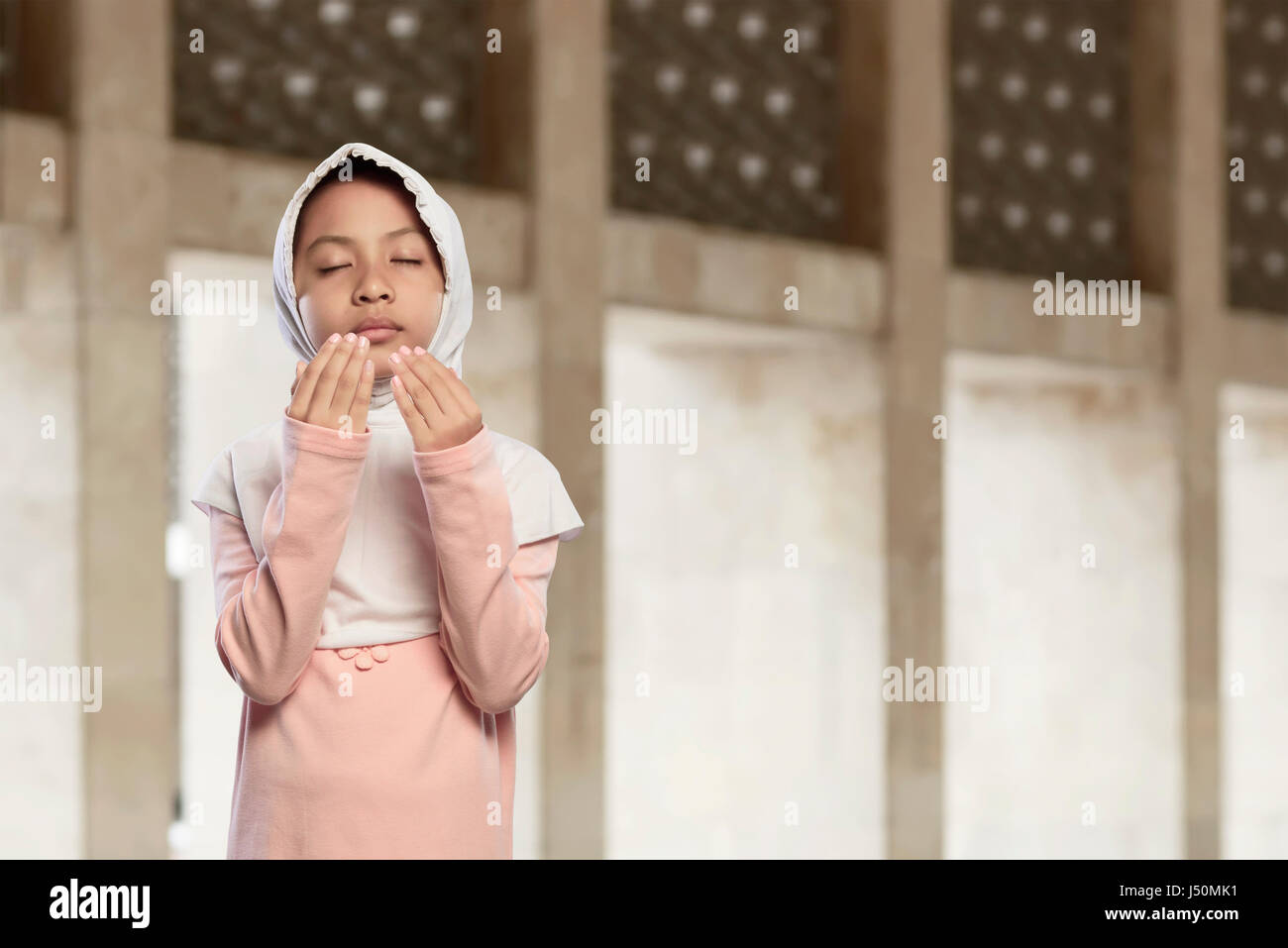Asian muslim kid in hijab praying to god in the mosque Stock Photo - Alamy