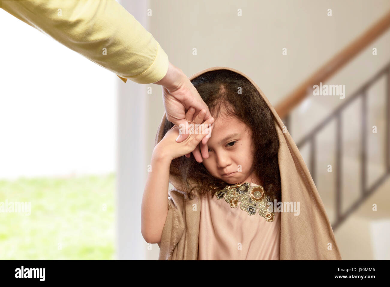 Asian muslim girl kissing hand parents as respect in the home Stock ...