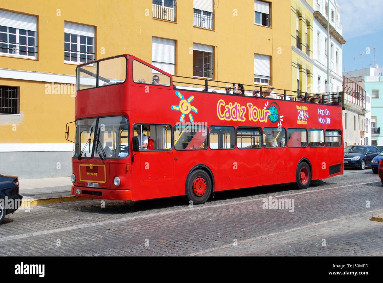 Passengers aboard a red open topped tour bus, Cadiz, Cadiz Province ...