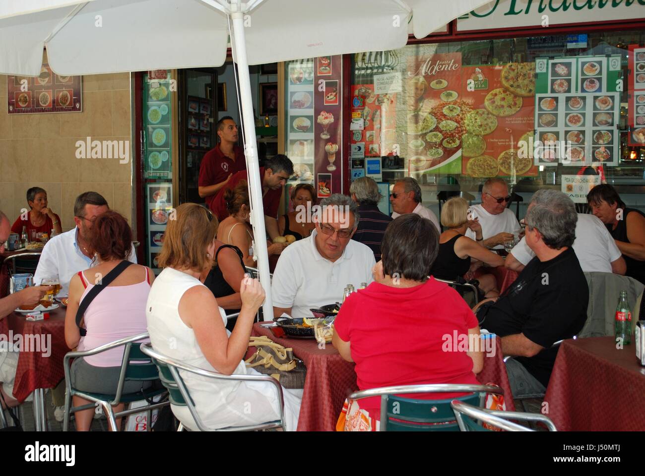 Tourists relaxing at a pavement cafe along Colunela, Cadiz, Cadiz ...