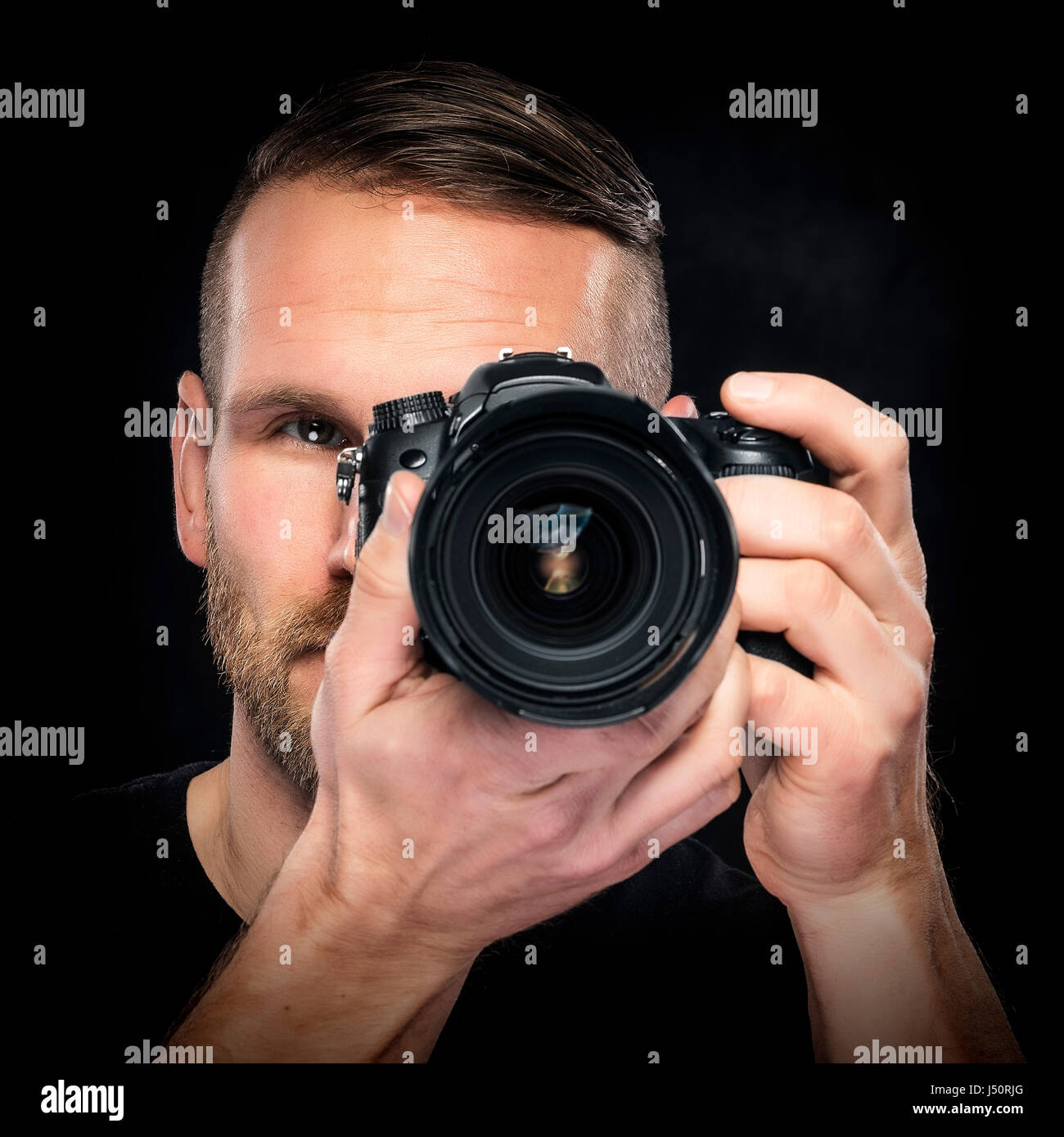 Photographer with camera on black Stock Photo - Alamy