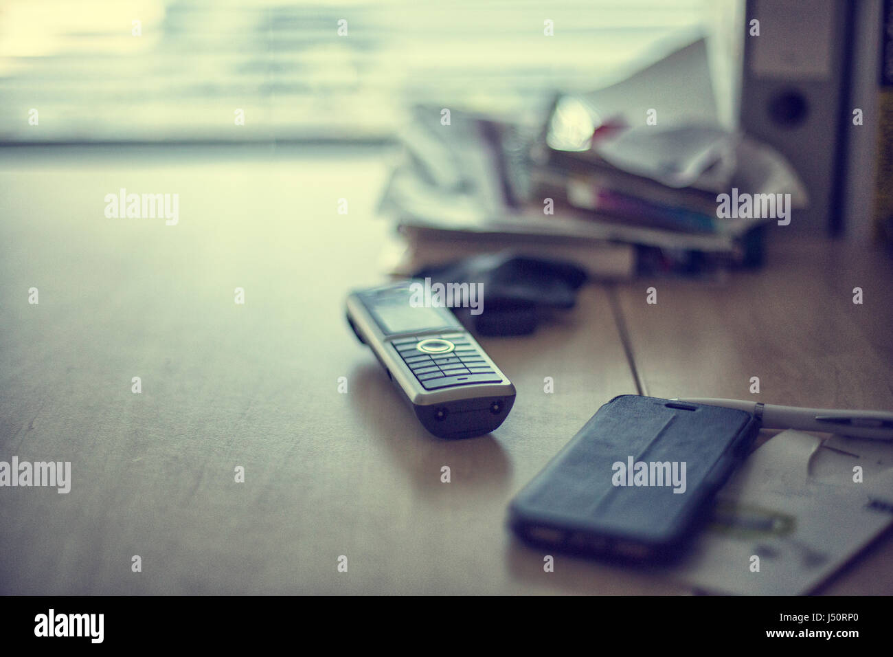 Working with two phones. Landline and smartphone on a desk Stock Photo ...