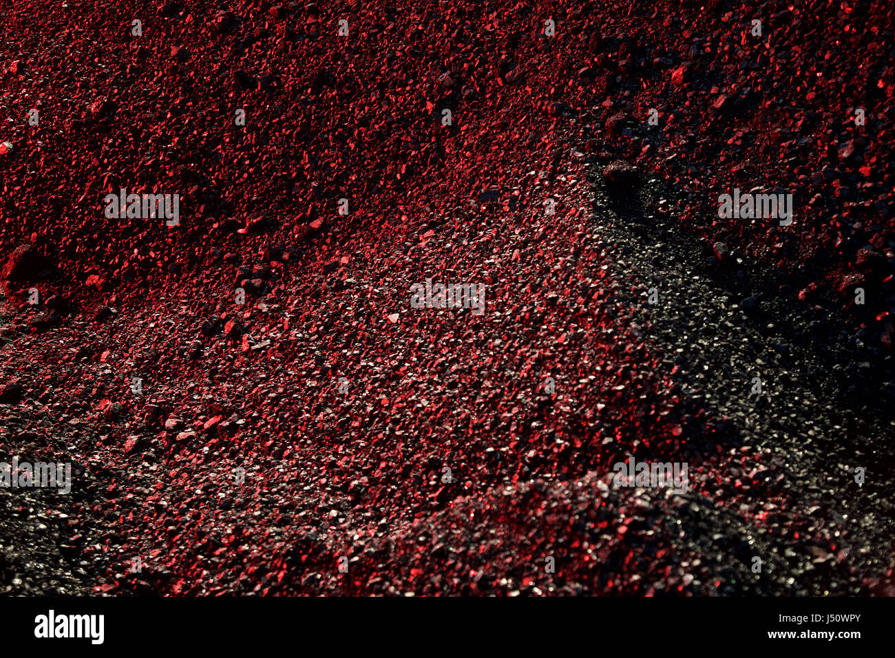 Heaps of coal in the red light Stock Photo - Alamy