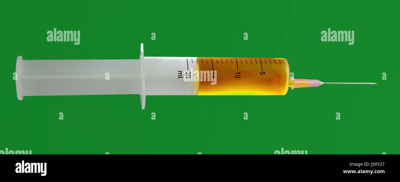 Isolated syringe with needle with yellow liquid on green background ...