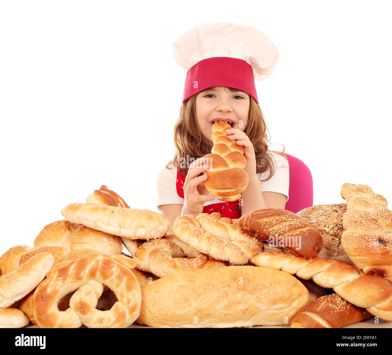 hungry little girl cook eat bread Stock Photo - Alamy