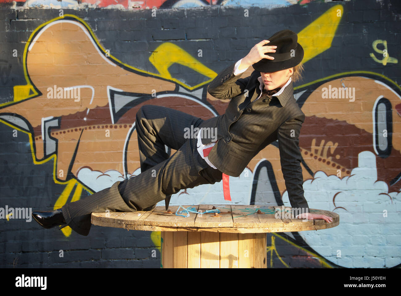 Beautiful girl in an urban location - graffiti covered wall Stock Photo ...