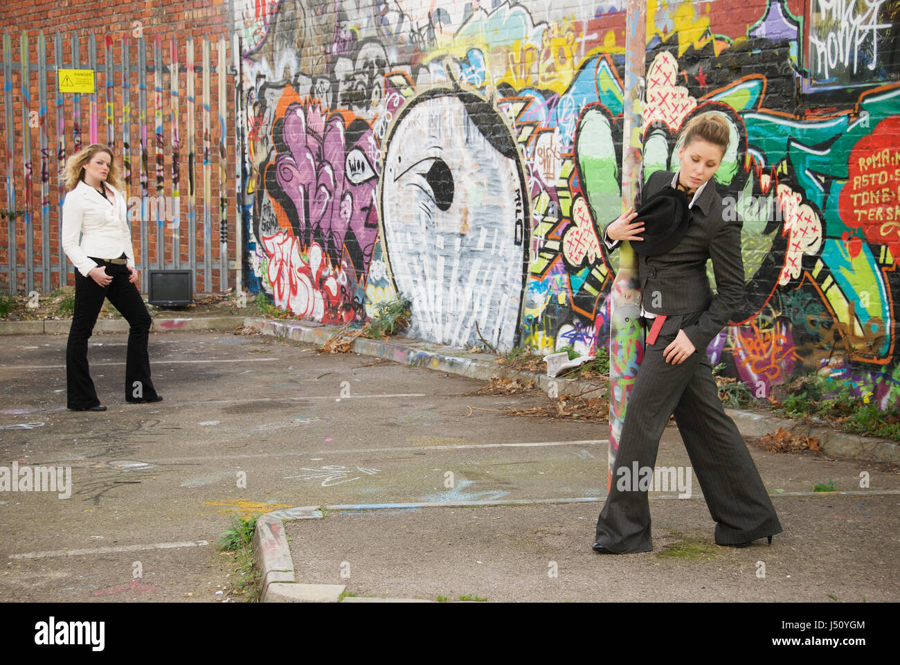 Two Beautiful girls in an urban location - graffiti covered wall Stock ...
