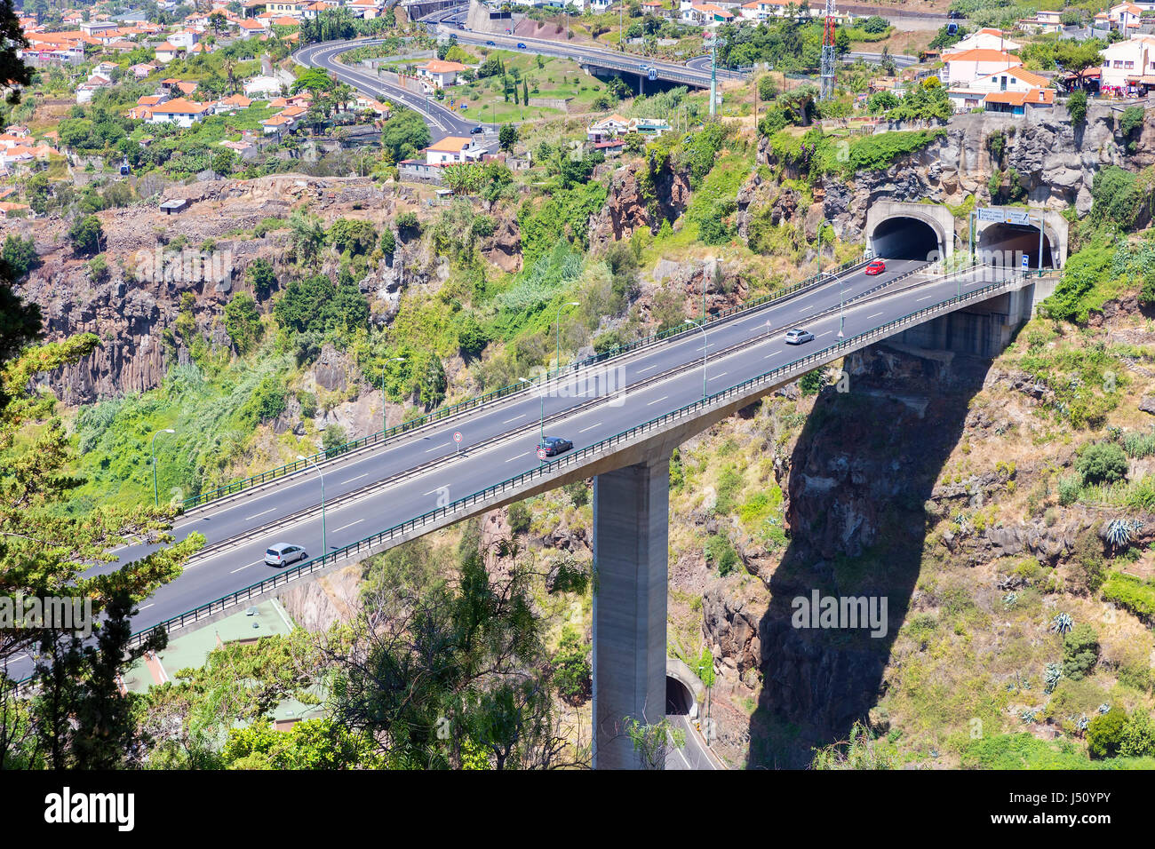 Cars driving on highway and overpass through tunnels at Madeira ...