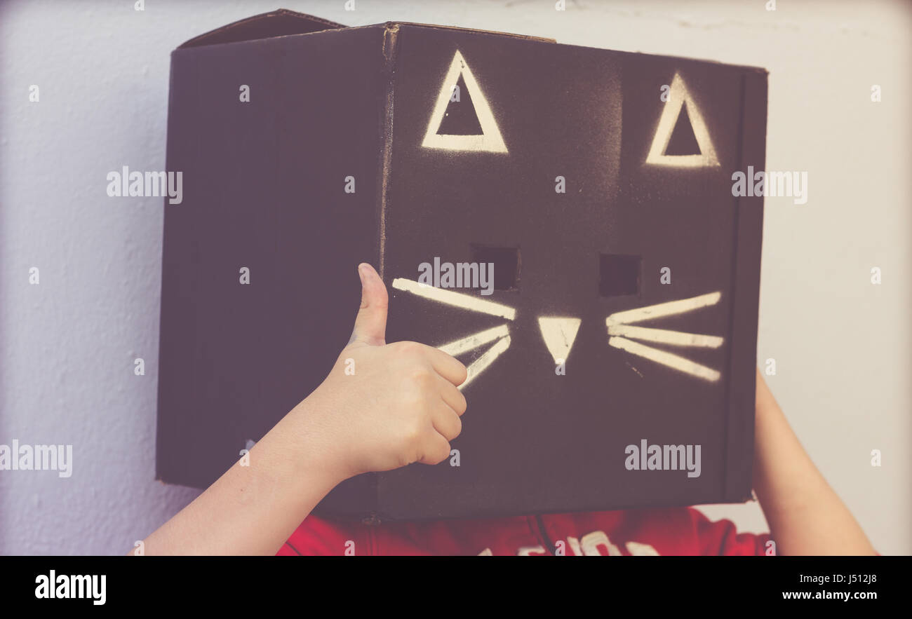 Photograph of a teen with a black cat carton box mask Stock Photo - Alamy