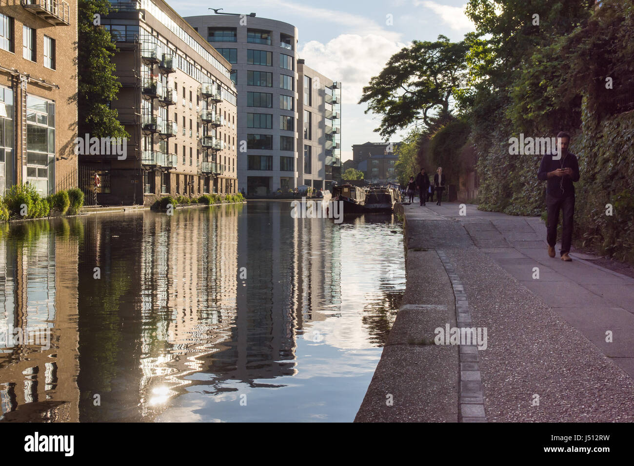 London, England - June 20, 2016: Pedestrians walk on the towpath of the ...