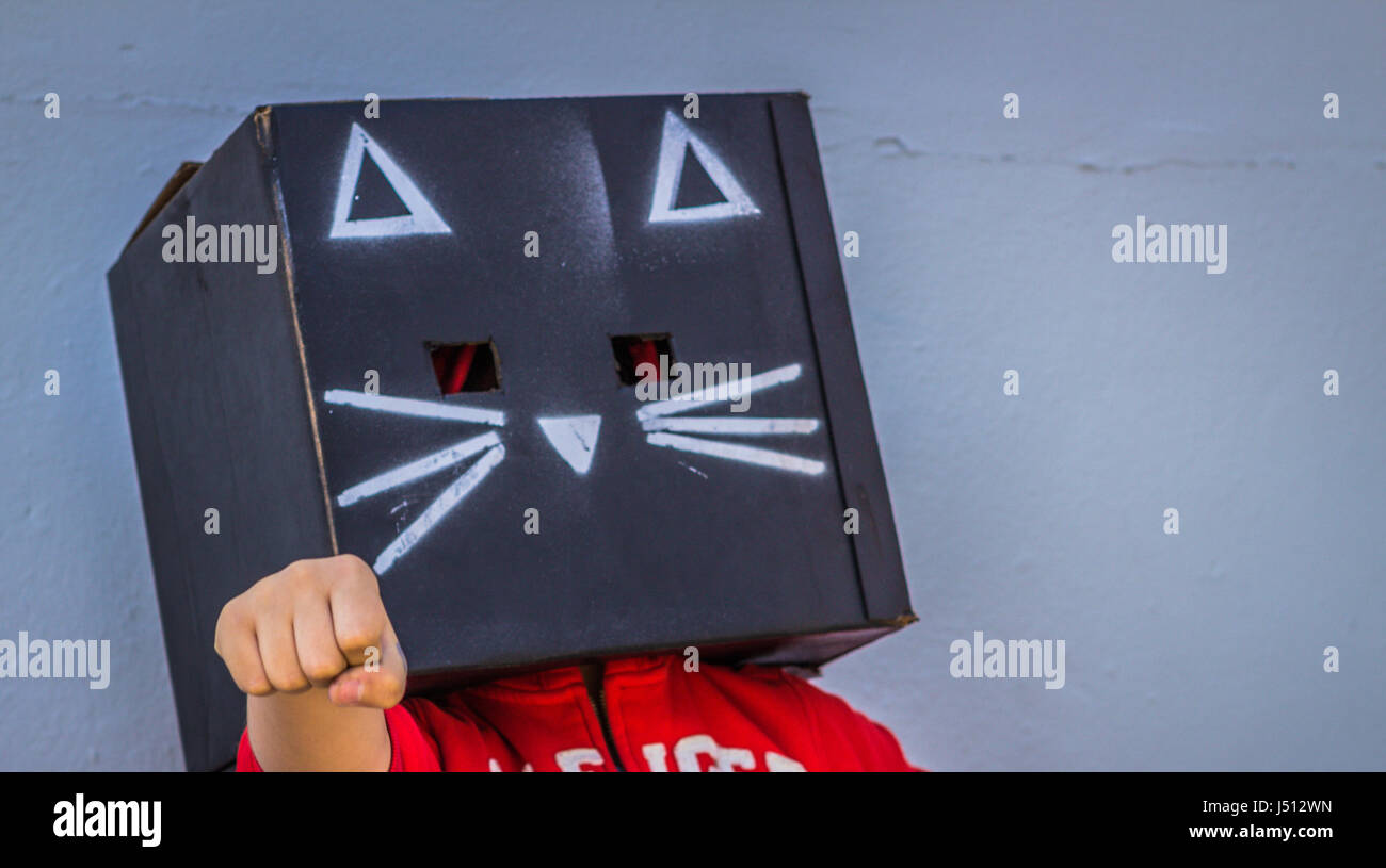 Photograph of a teen with a black cat carton box mask Stock Photo - Alamy
