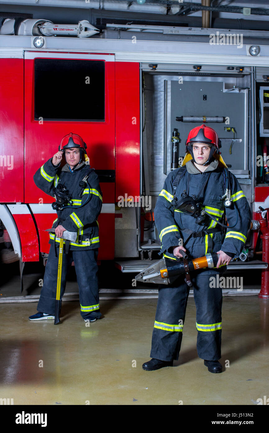 Portrait of a fireman with car on background Stock Photo - Alamy