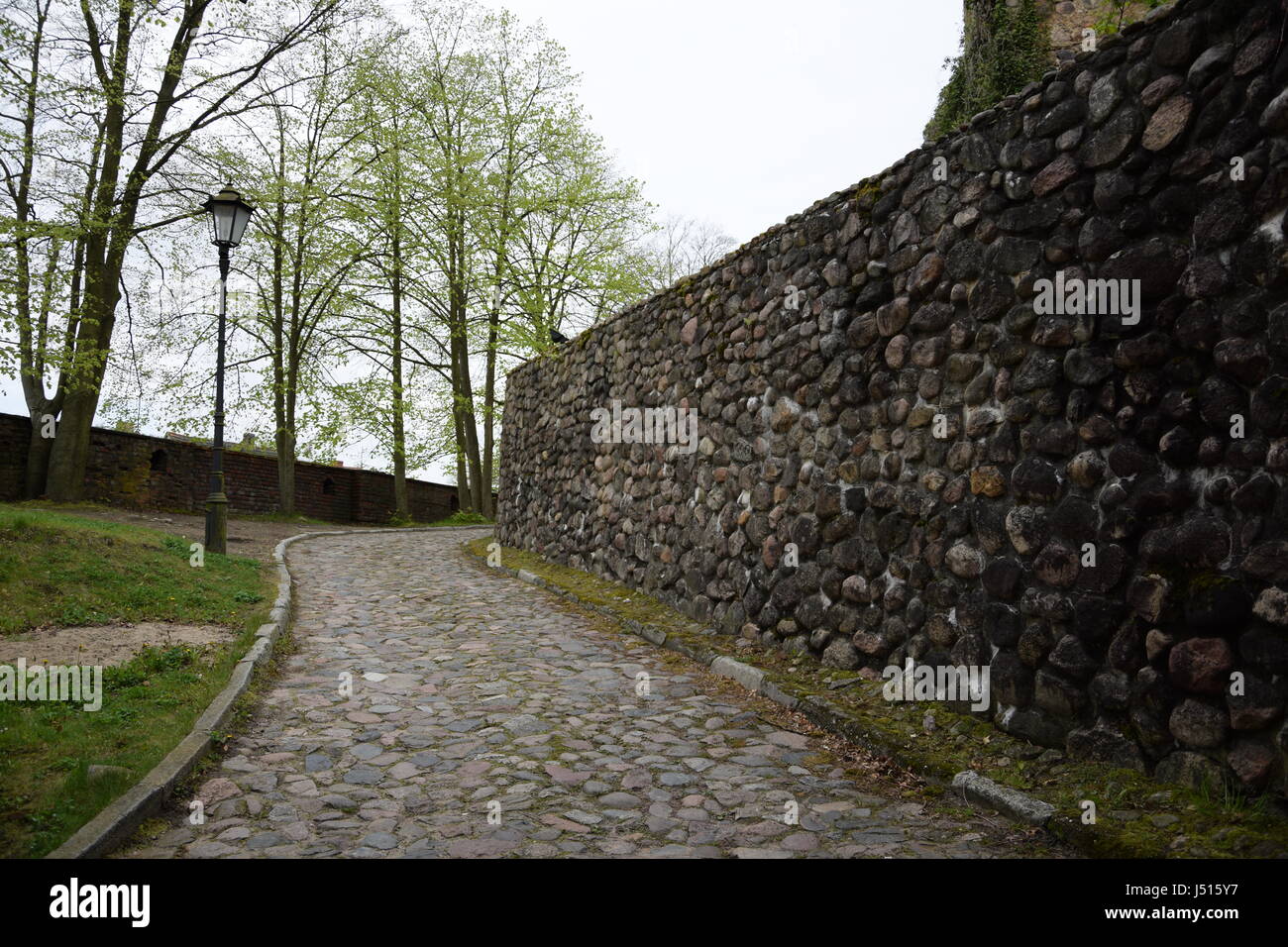 Old stone road and medieval wall Stock Photo - Alamy