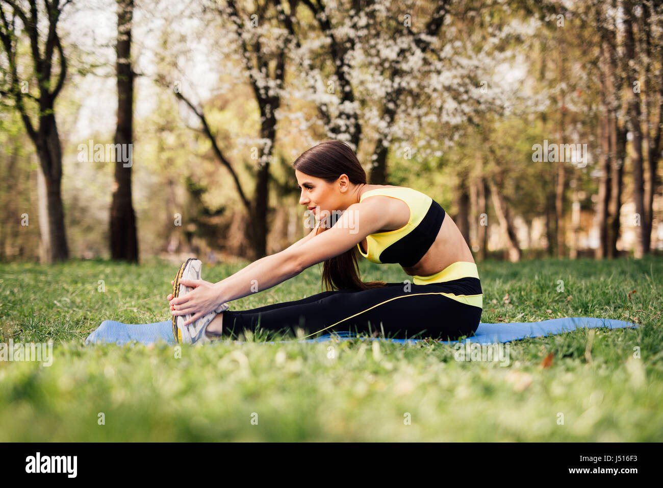 woman runner stretching legs outdoor in park Stock Photo - Alamy