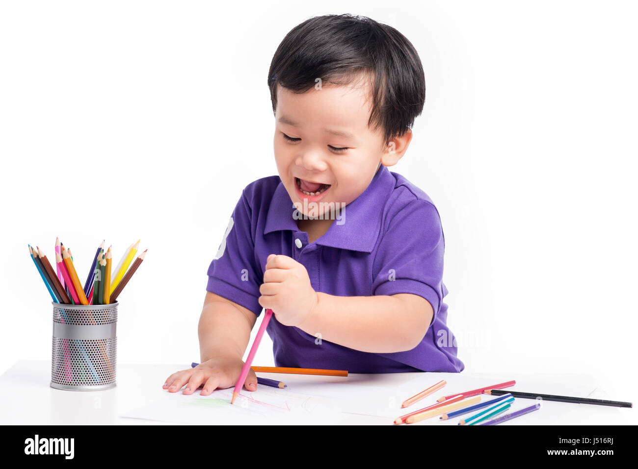 Portrait of cheerful boy drawing with colorful pencils Stock Photo - Alamy