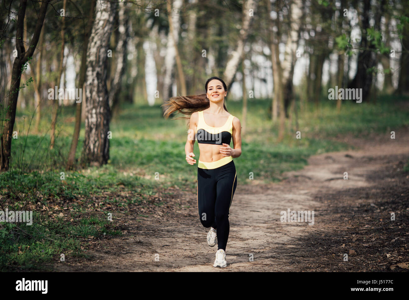 Running woman. Slim Female Runner Jogging during Outdoor Workout in a ...