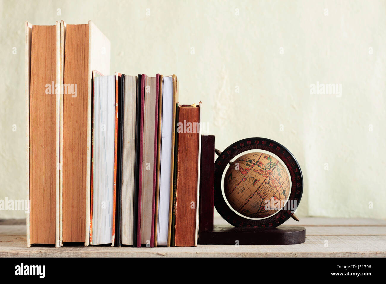 Old school textbooks and globe on wooden boards Stock Photo - Alamy