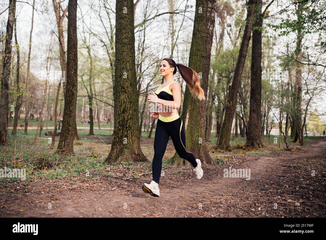 Running woman. Female Runner Jogging during Outdoor Workout in a Park ...
