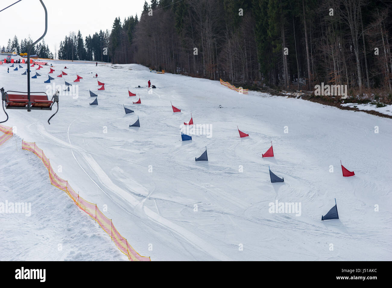 Red and blue flags on ski descents during competitions in winter period ...