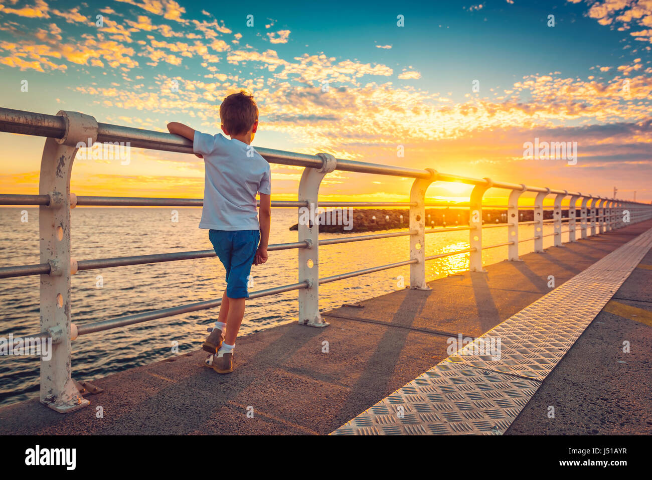 Boy watching sunset hi-res stock photography and images - Alamy