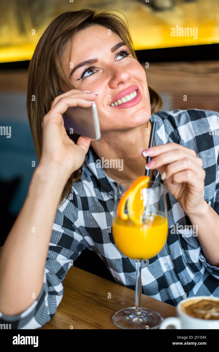 Beautiful young woman using cell telephone while enjoying her free time ...