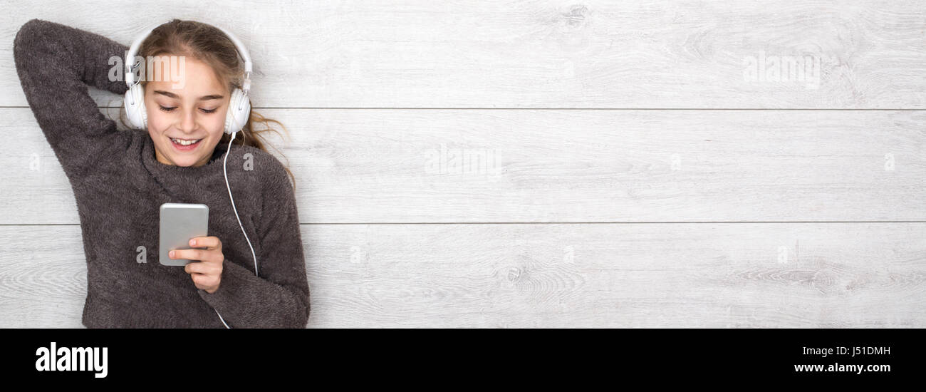 Young girl using smartphone top view header Stock Photo - Alamy