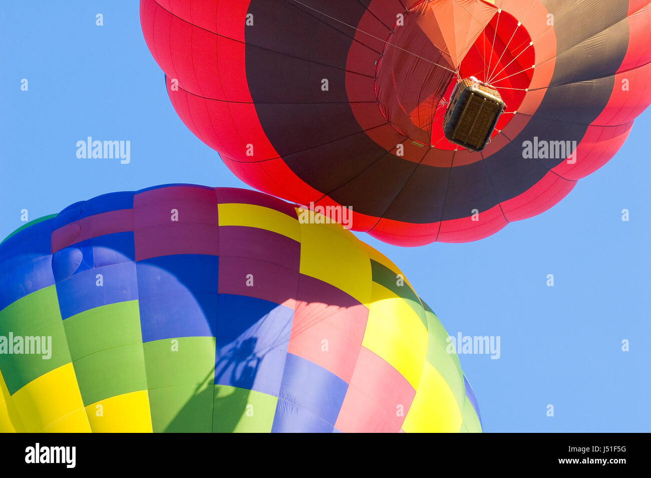 Two hot air balloons bumping each other as they lift off. This image ...