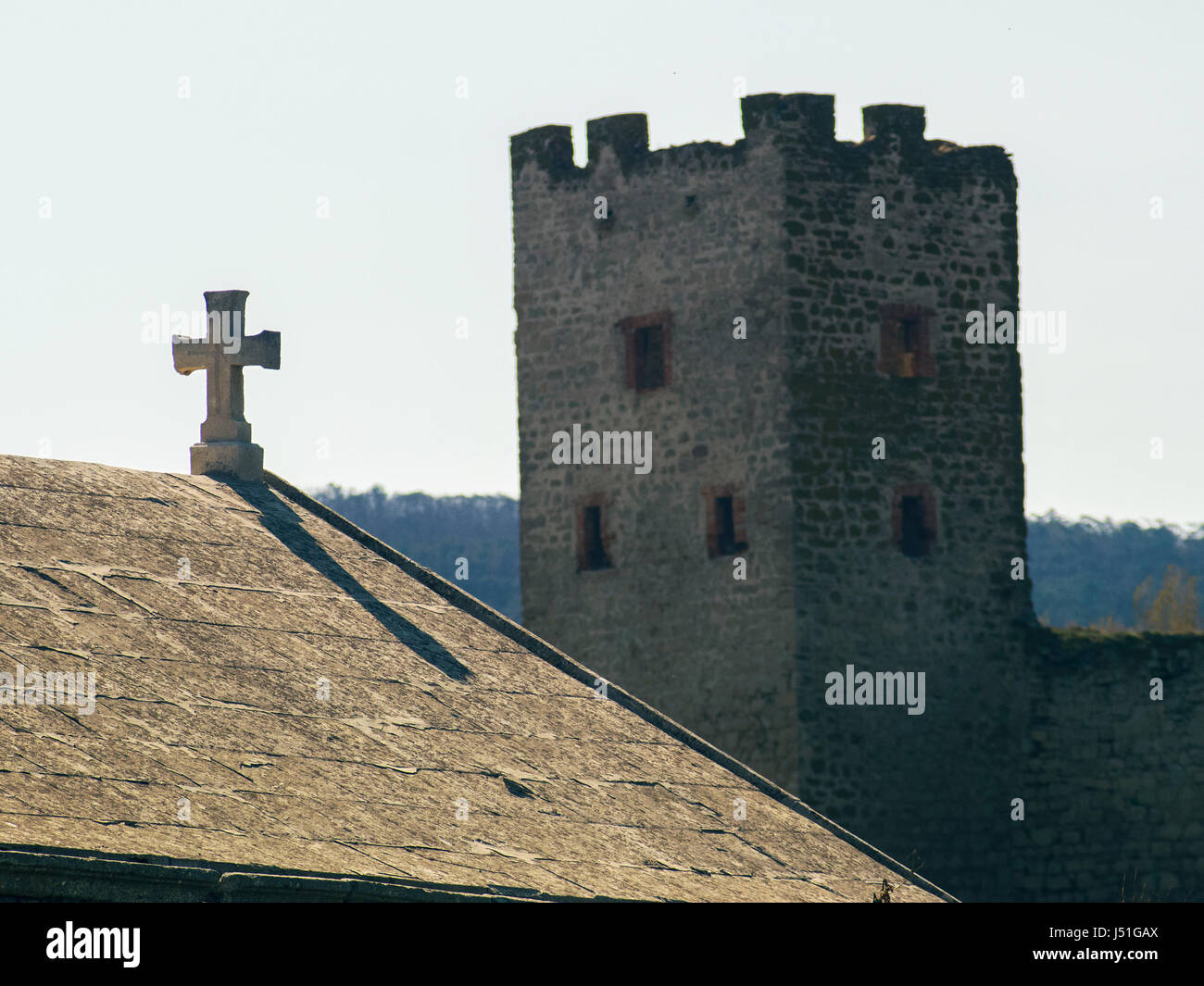 An ancient cross on the roof and a fortress tower Stock Photo - Alamy