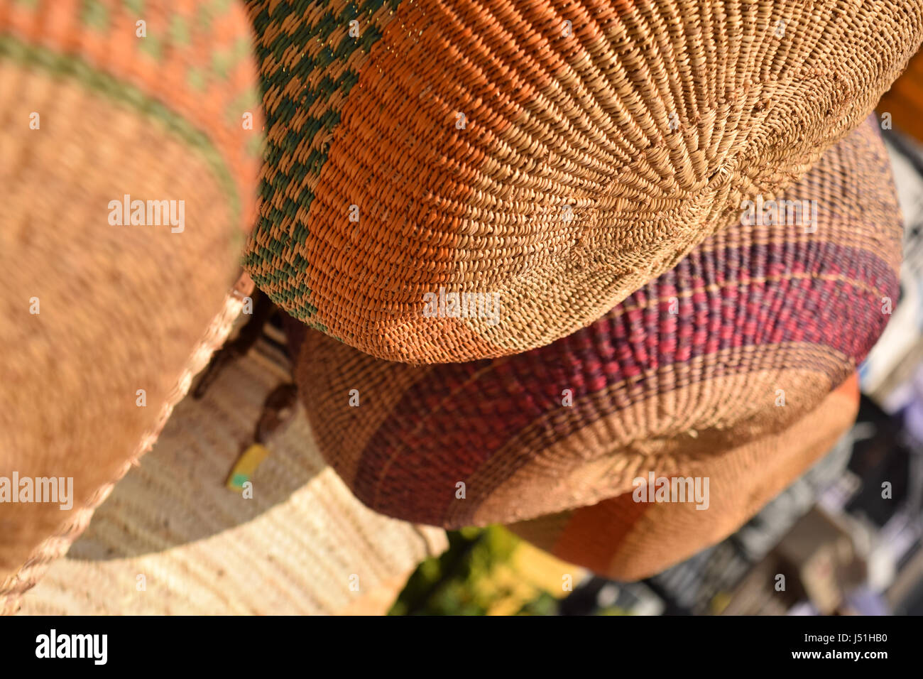 A view of a display of rattan colorful baskets at a street market stand ...