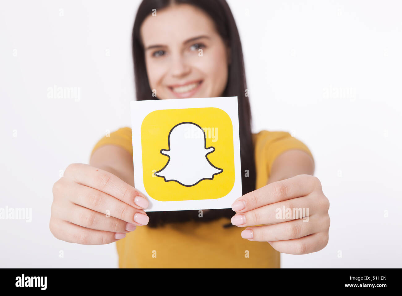 Kiev, Ukraine - August 22, 2016: Woman Hands holding Snapchat logo icon ...