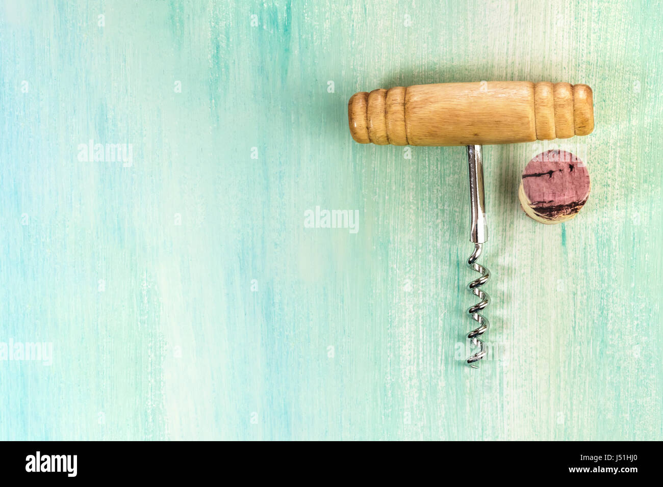 A photo of an old-fashioned corkscrew with a cork, shot from above on a ...