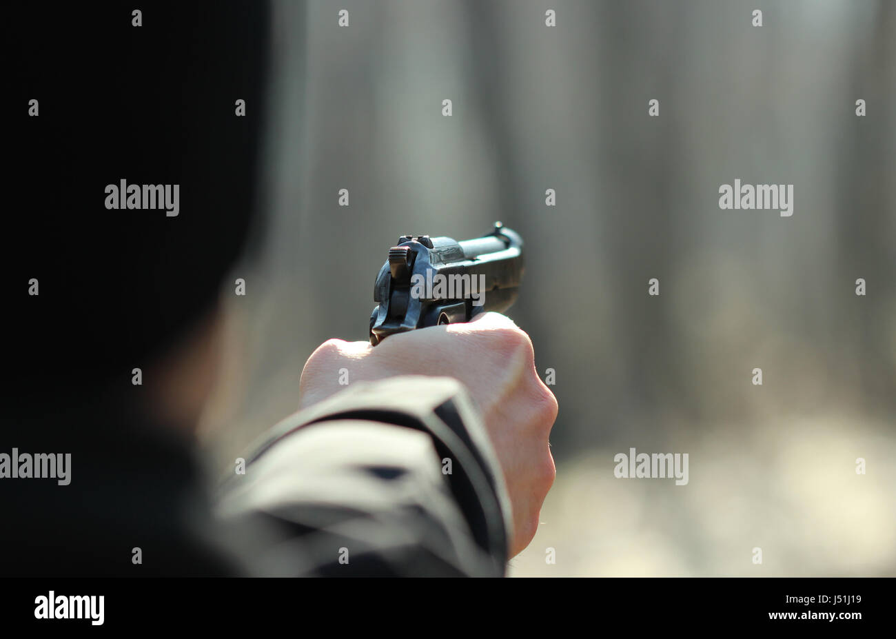 Gun in the hand Stock Photo - Alamy