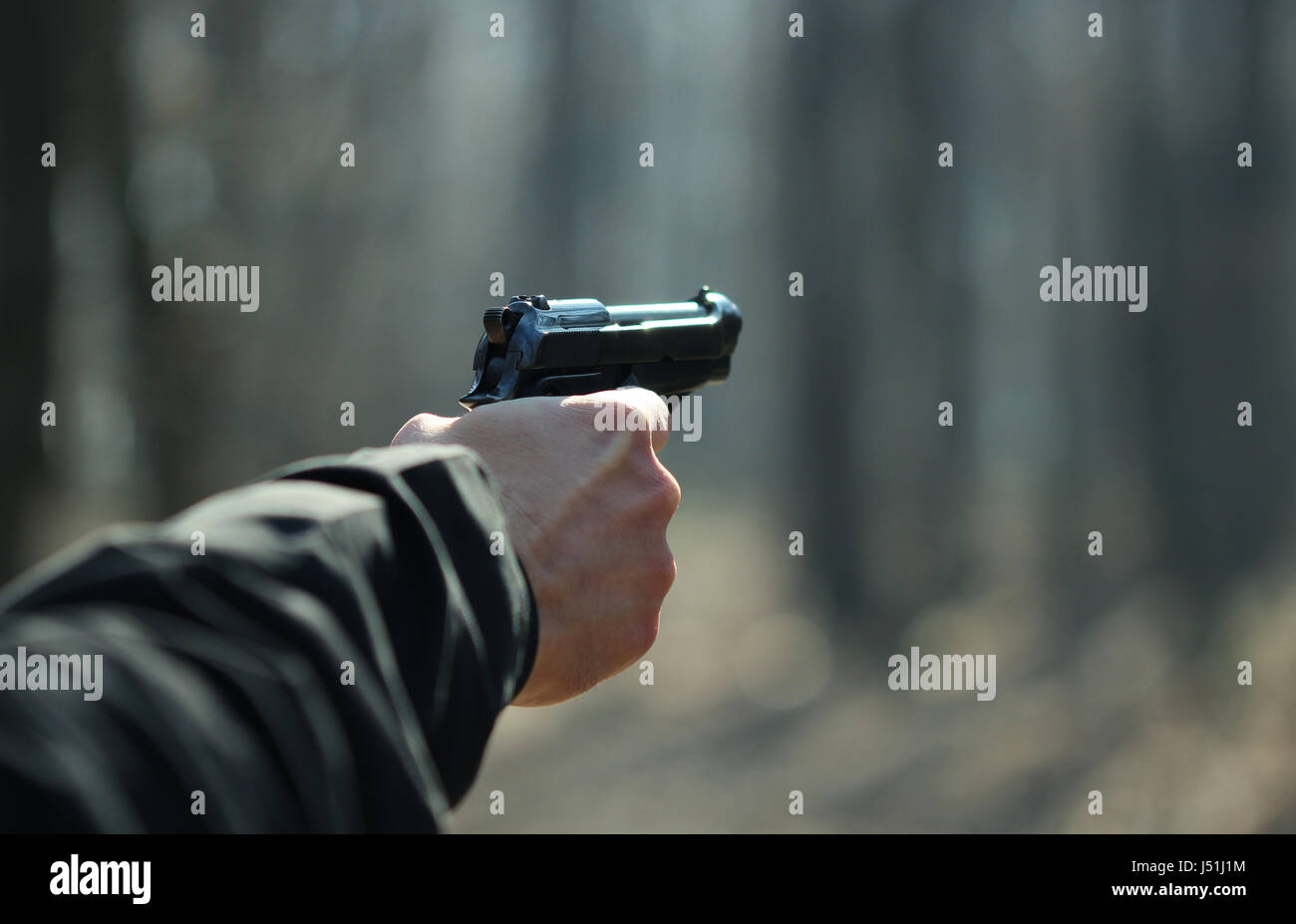 Gun in the hand Stock Photo - Alamy