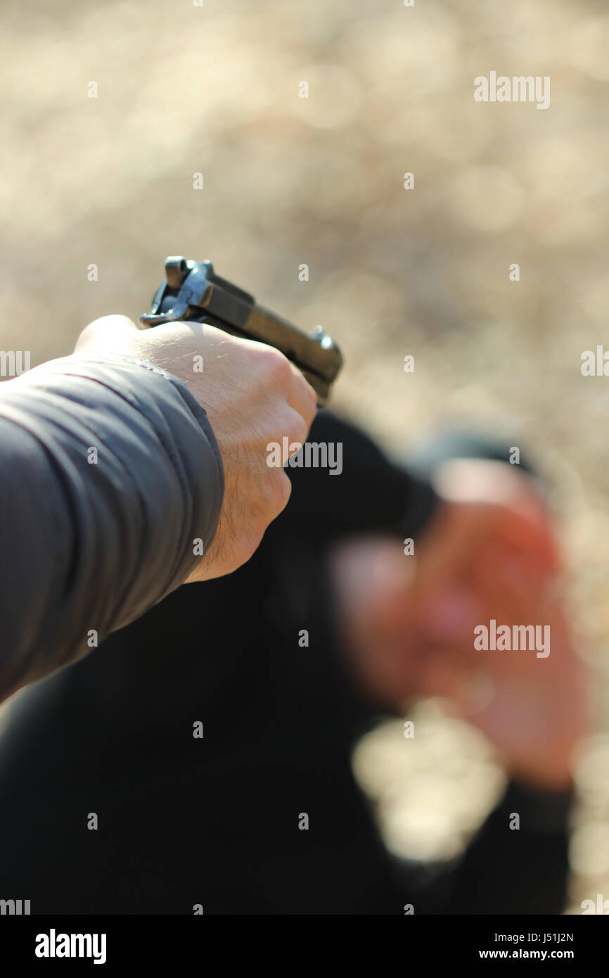 Gun in the hand Stock Photo - Alamy