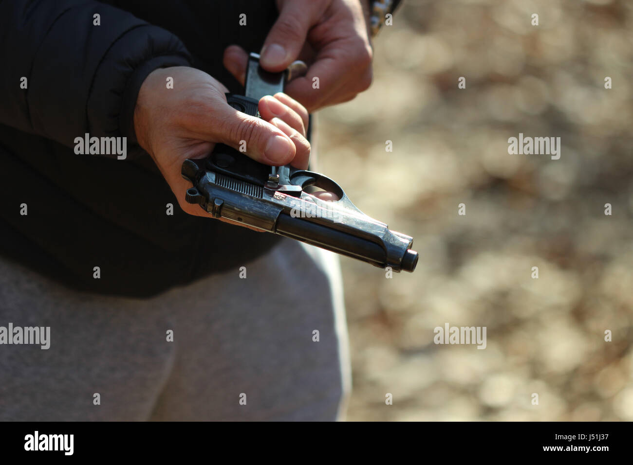 Gun in the hand Stock Photo - Alamy