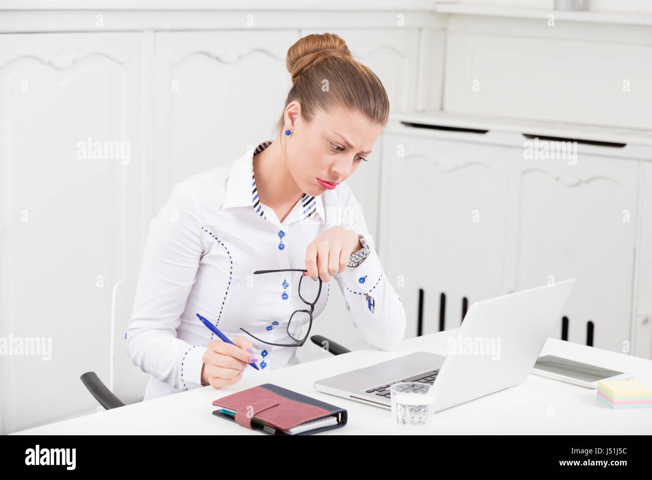 Portrait of worried businesswoman at the desk in the office Stock Photo ...