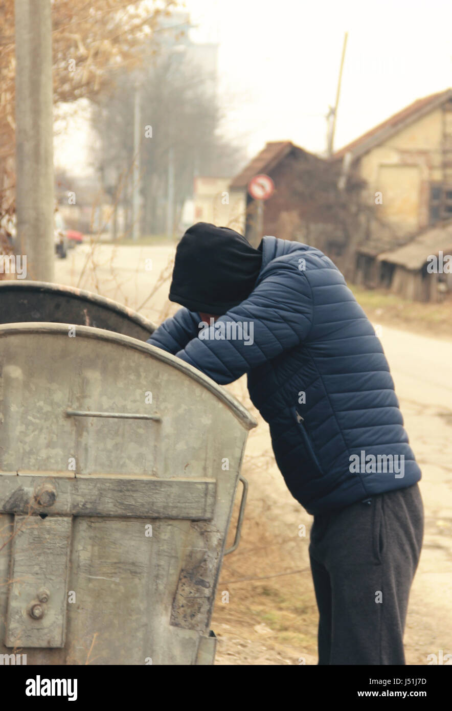 A homeless man looking for food Stock Photo - Alamy