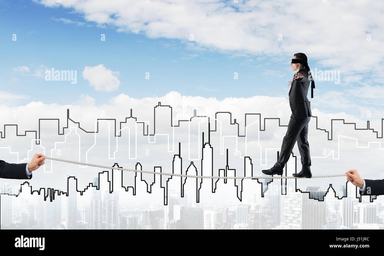 Business concept of risk support and assistance with man balancing on ...