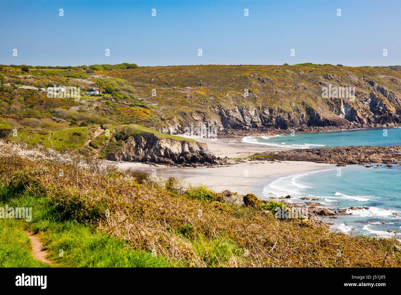 On the coast path approaching the Sandy beach at Kennack Sands on the ...